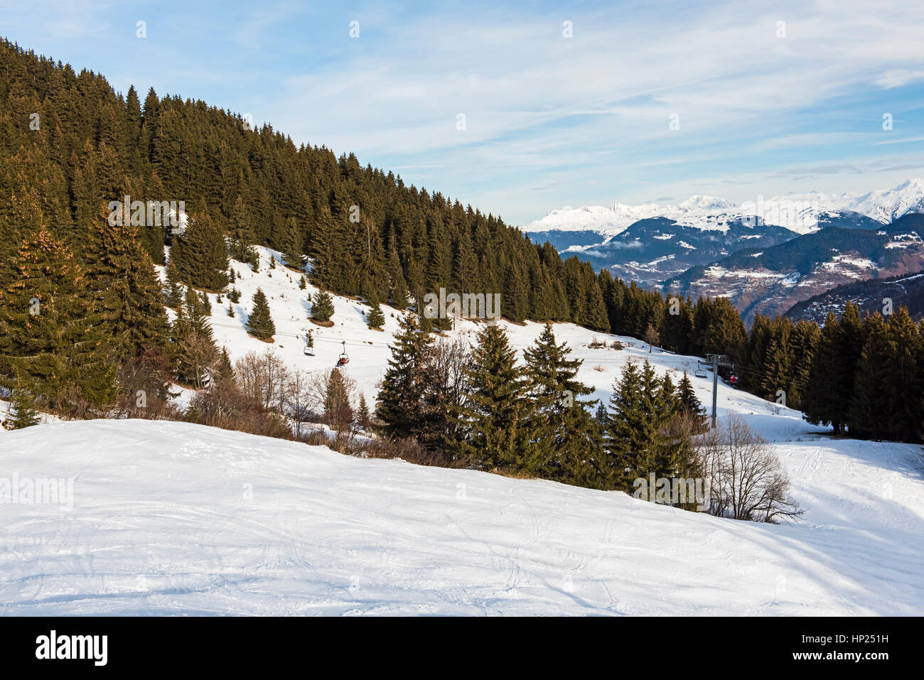 Panoramic view down snow covered valley in alpine mountain range with ...