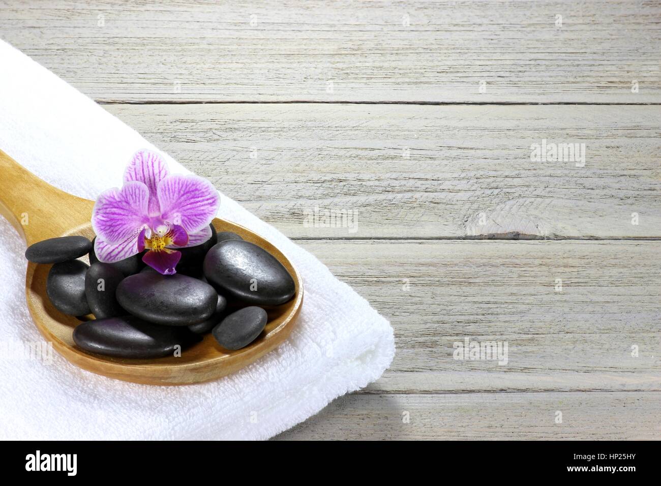 basalt stones for hot stone massage with accessories on wooden ...