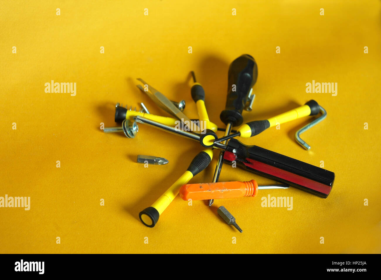 Bunch of various work tools on yellow, studio closeup Stock Photo - Alamy
