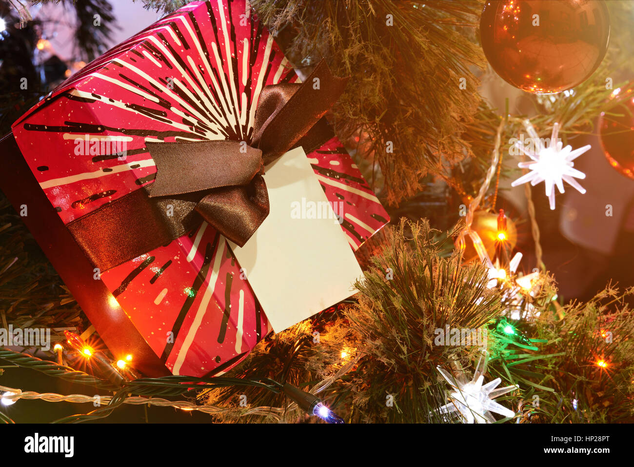christmas red box on tree with decorations background Stock Photo - Alamy