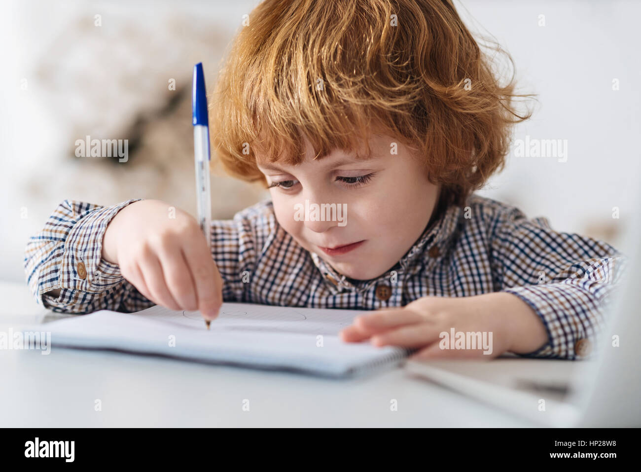 Focused diligent child writing an essay Stock Photo - Alamy