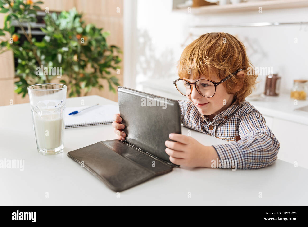 Adorable child reading something on his tablet Stock Photo - Alamy