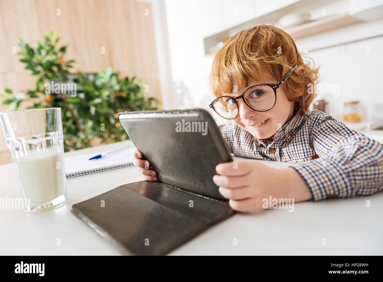 Funny smart boy using his tablet Stock Photo - Alamy