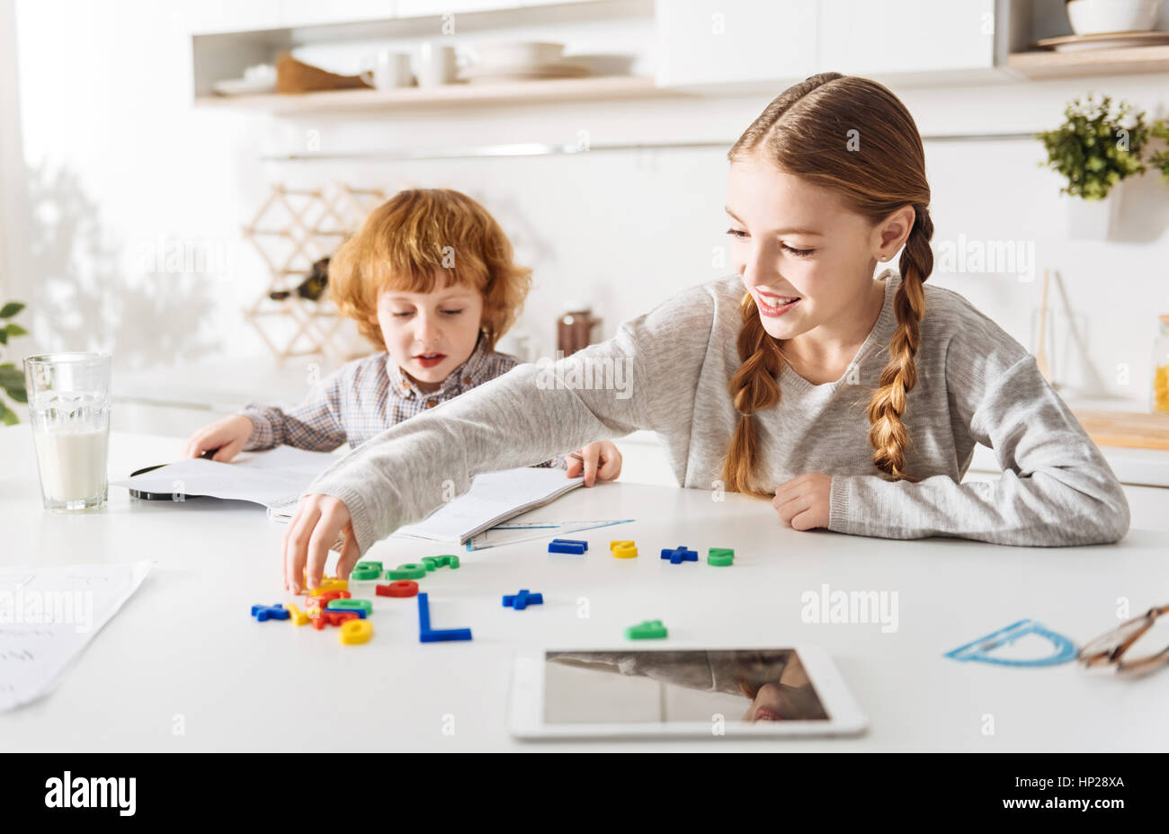 Adorable clever siblings doing math together Stock Photo - Alamy