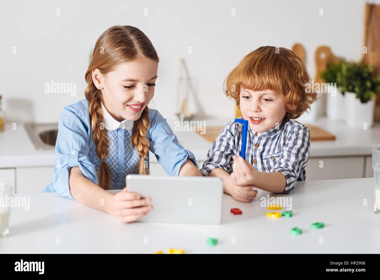 Adorable siblings talking to their parents using tablet Stock Photo - Alamy