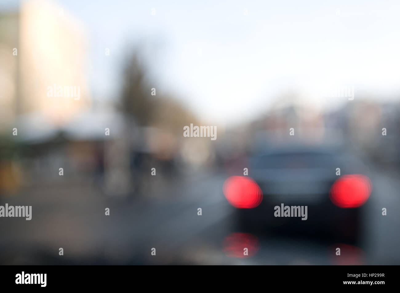 Traffic abstract background with blurry buildings, street signs and ...