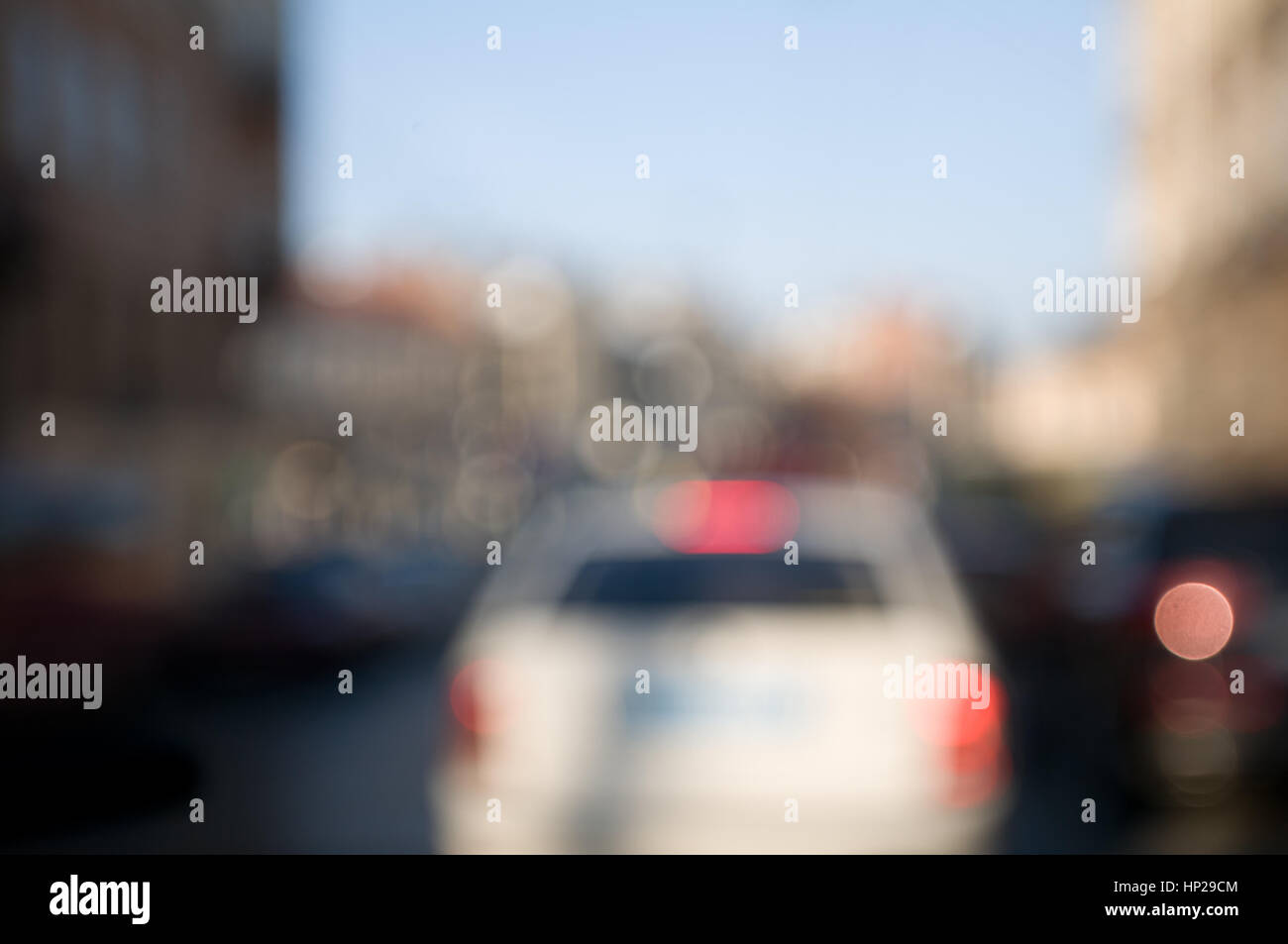 Traffic abstract background with blurry buildings, street signs and ...