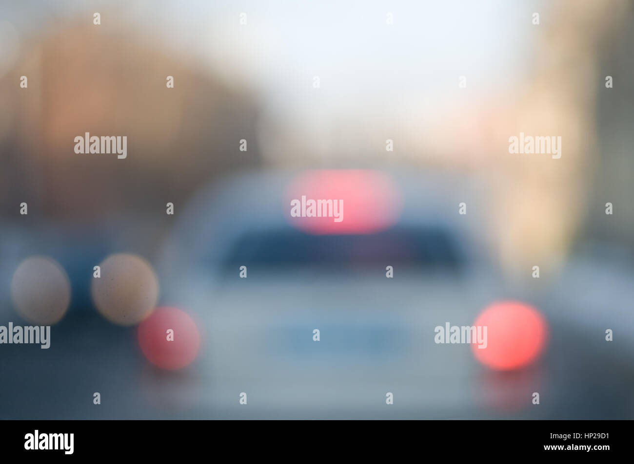 Traffic abstract background with blurry buildings, street signs and ...
