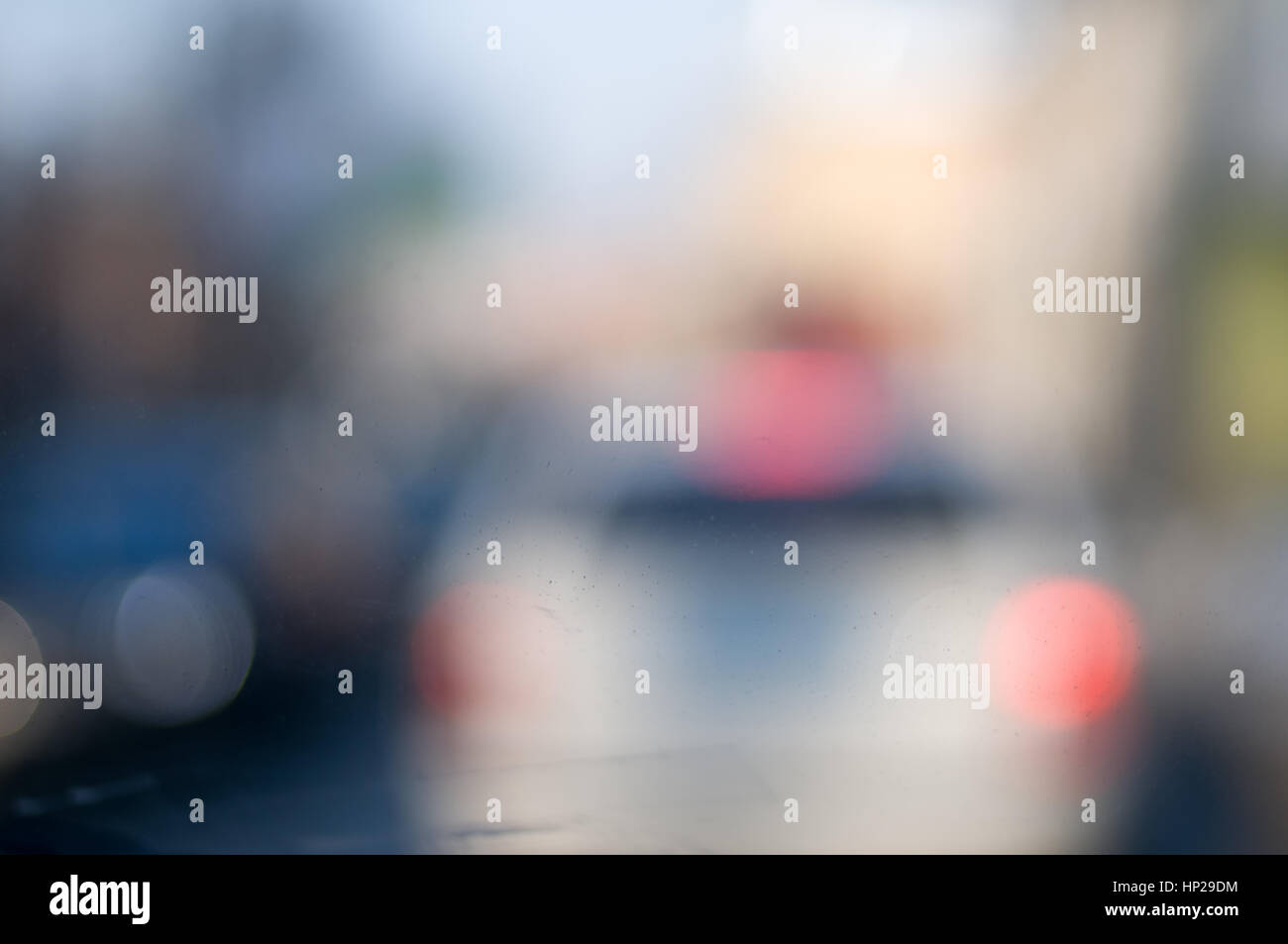 Traffic abstract background with blurry buildings, street signs and ...