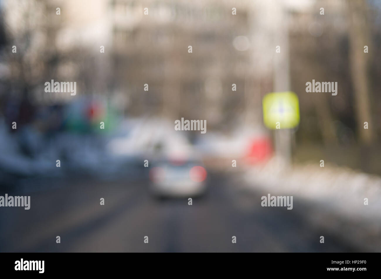 Traffic abstract background with blurry buildings, street signs and ...
