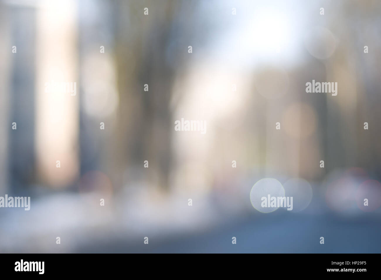 Abstract background with blurry buildings, street signs and cars in ...