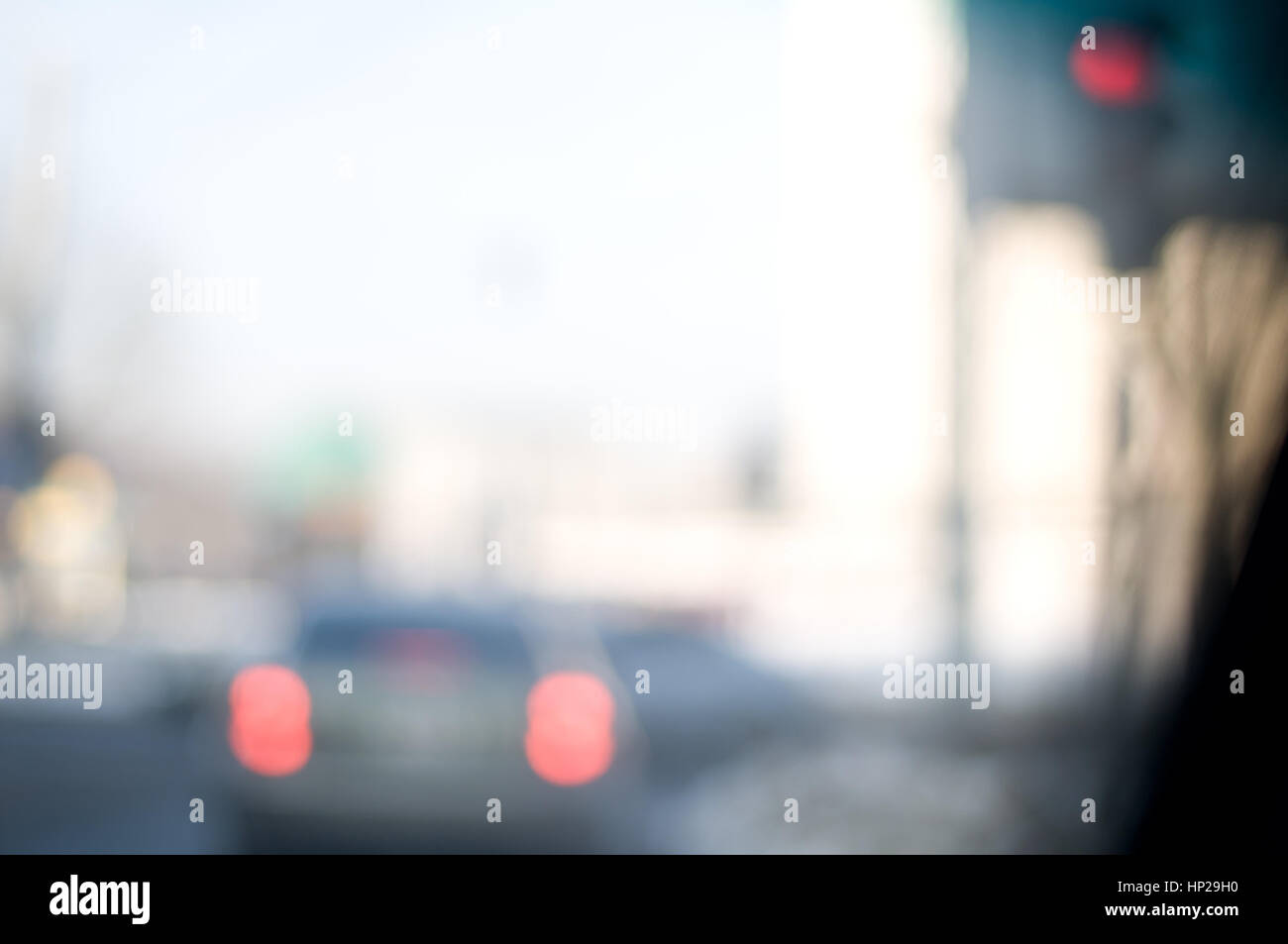 Traffic abstract background with blurry buildings, street signs and ...