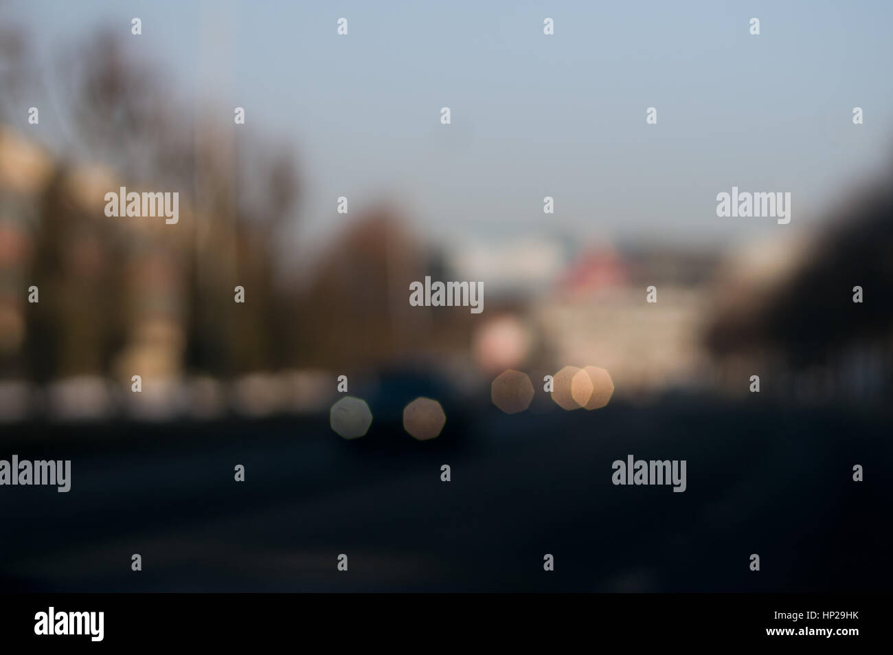 Traffic abstract background with blurry buildings, street signs and ...
