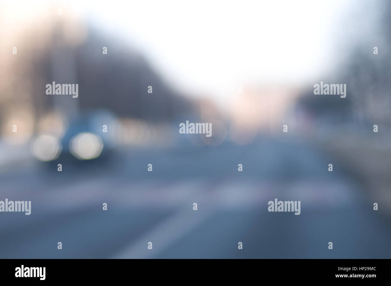Traffic abstract background with blurry buildings, street signs and ...