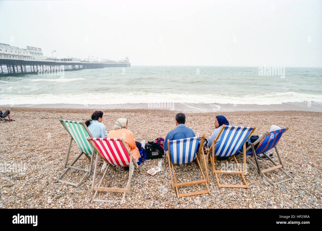 Family enjoying a spring day out on Brighton beach Stock Photo - Alamy