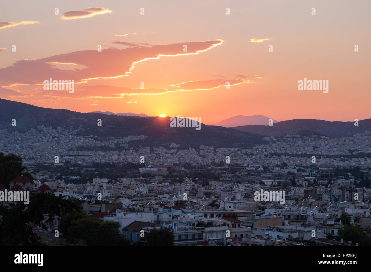 The sun setting in Athens Stock Photo - Alamy