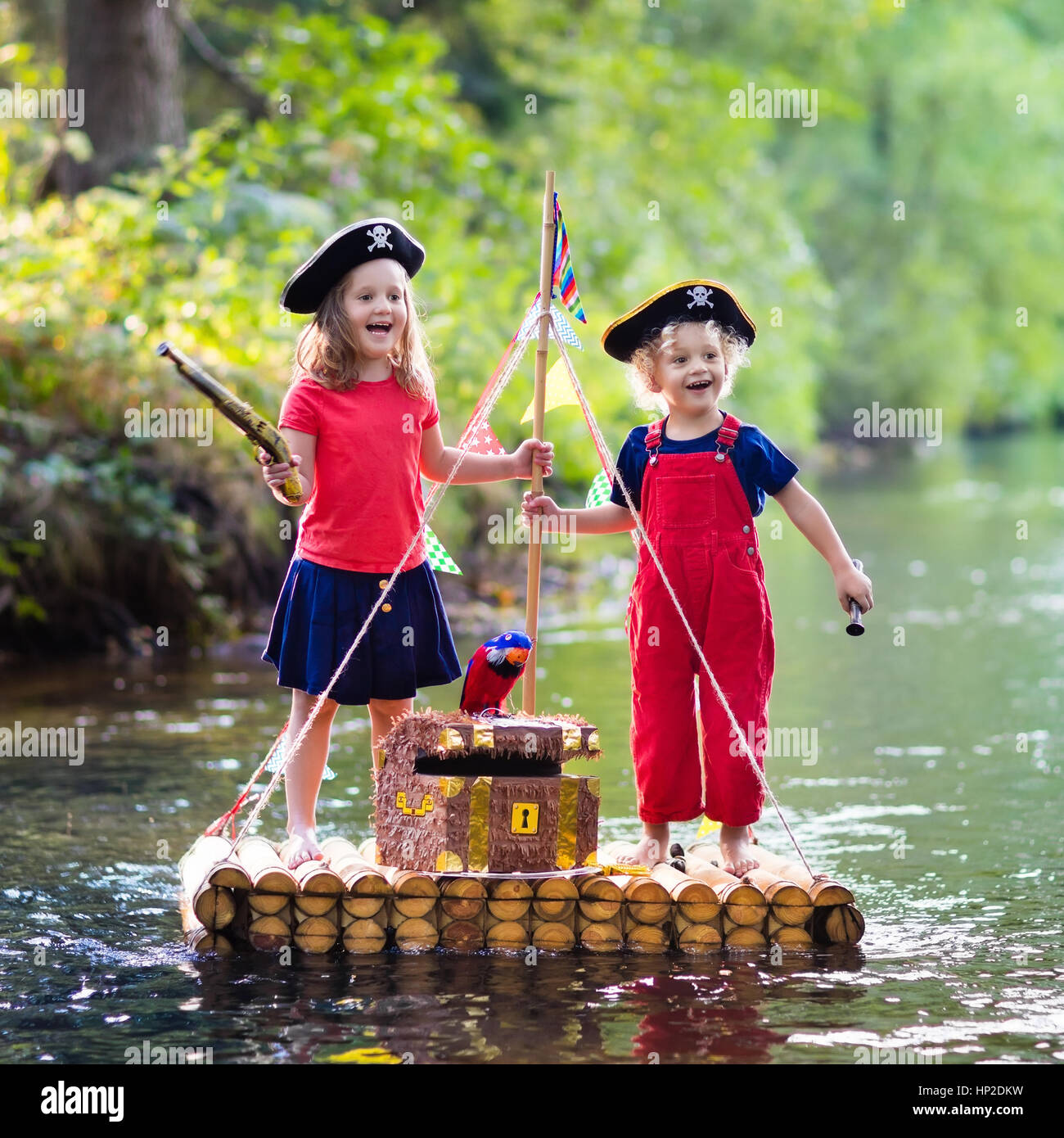 Kids dressed in pirate costumes and hats with treasure chest ...