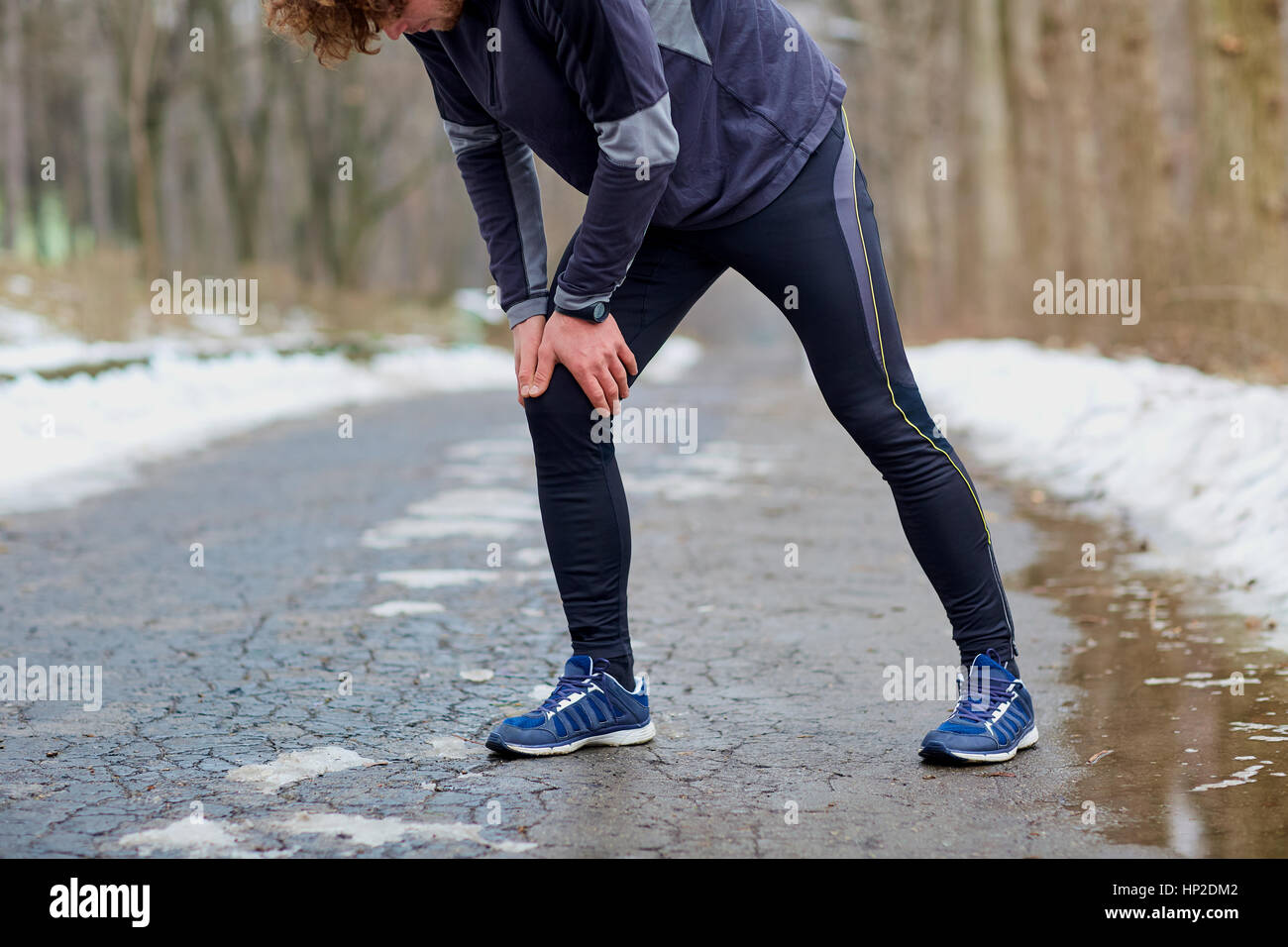 Injury while running in the winter spring autumn Stock Photo - Alamy