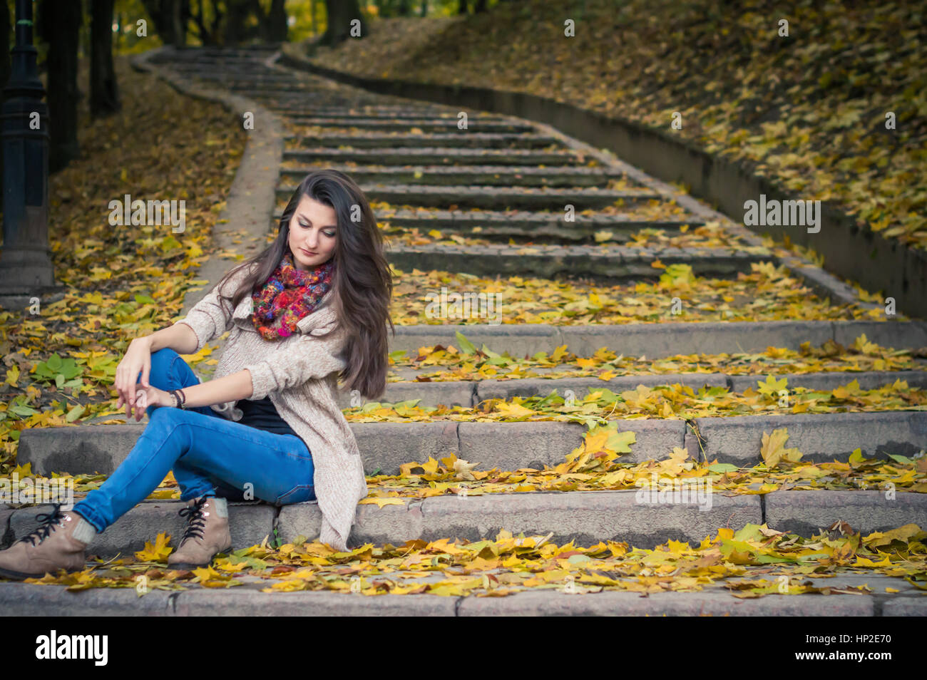 girl sitting on stone steps Stock Photo - Alamy