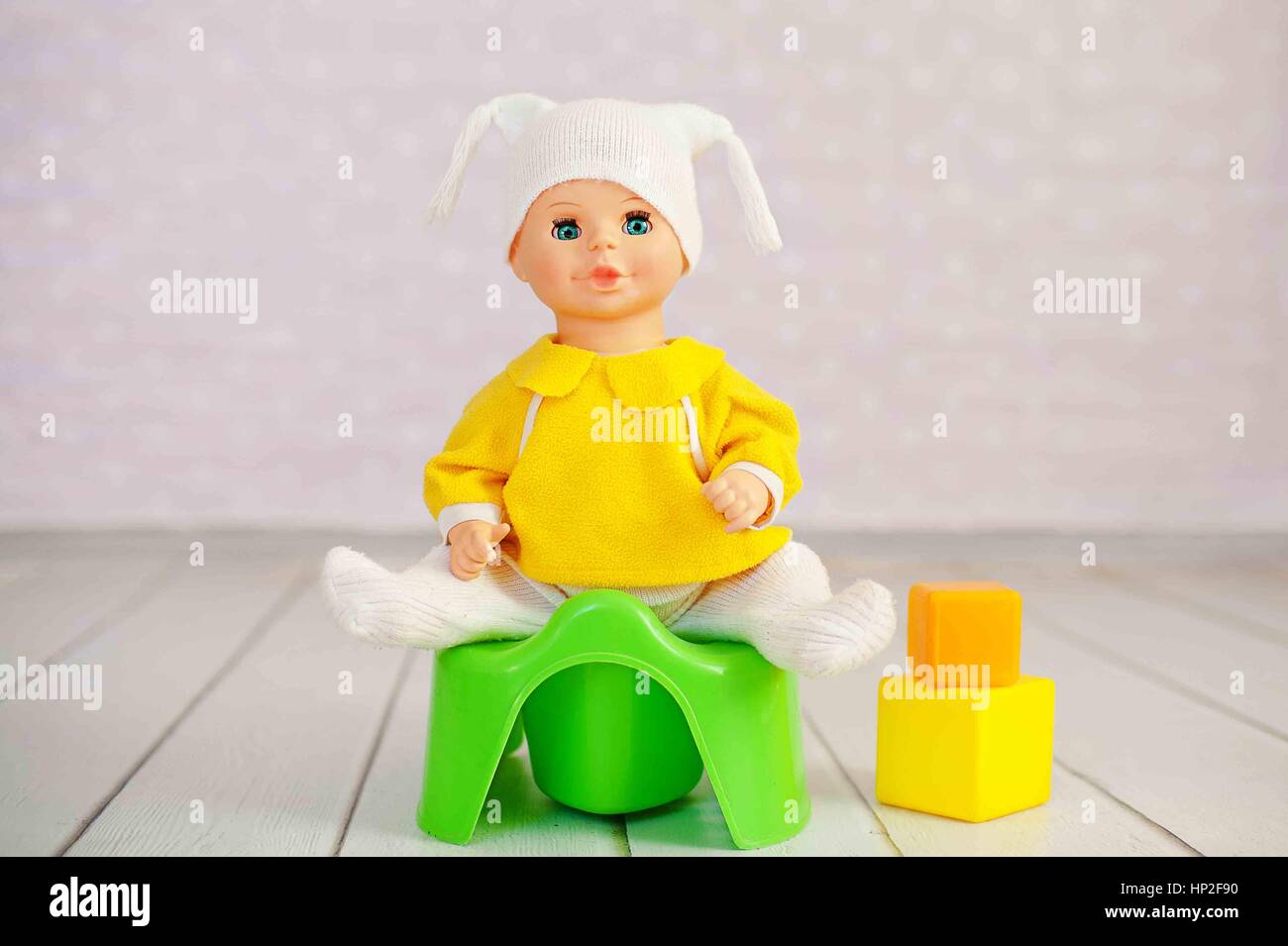 Potty training concept using a doll and toy potty Stock Photo - Alamy
