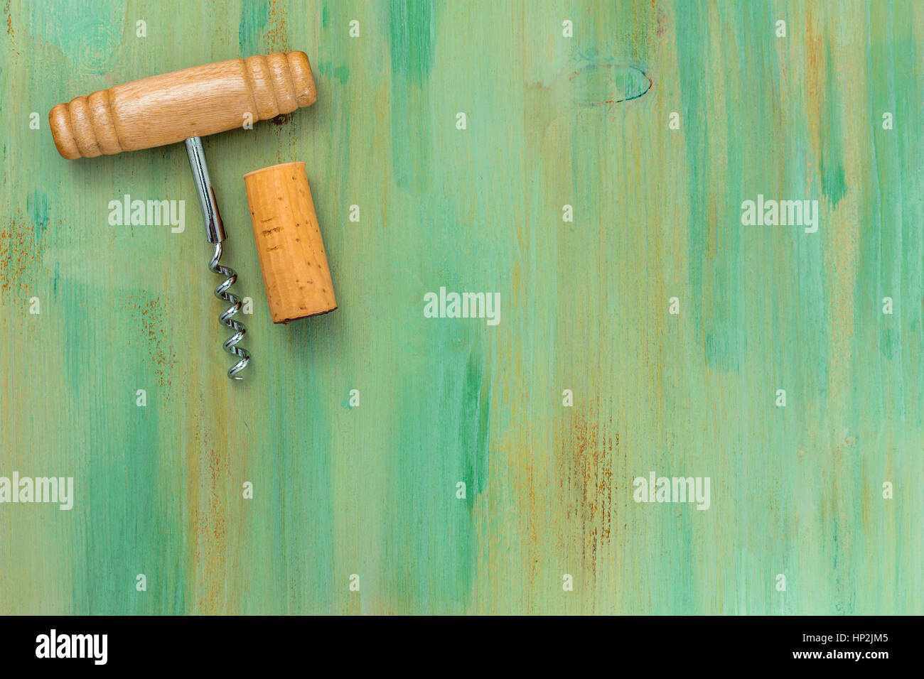 A photo of an old-fashioned corkscrew with a cork, shot from above on a ...