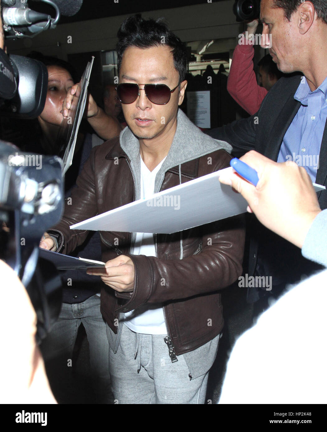 Donnie Yen is surrounded by fans wanting autographs as he arrives at ...