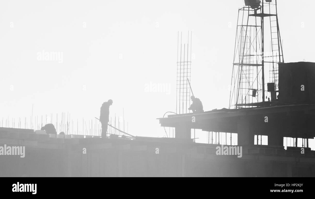 builders working on the construction site, erecting and concrete reinforcement, workflow ...