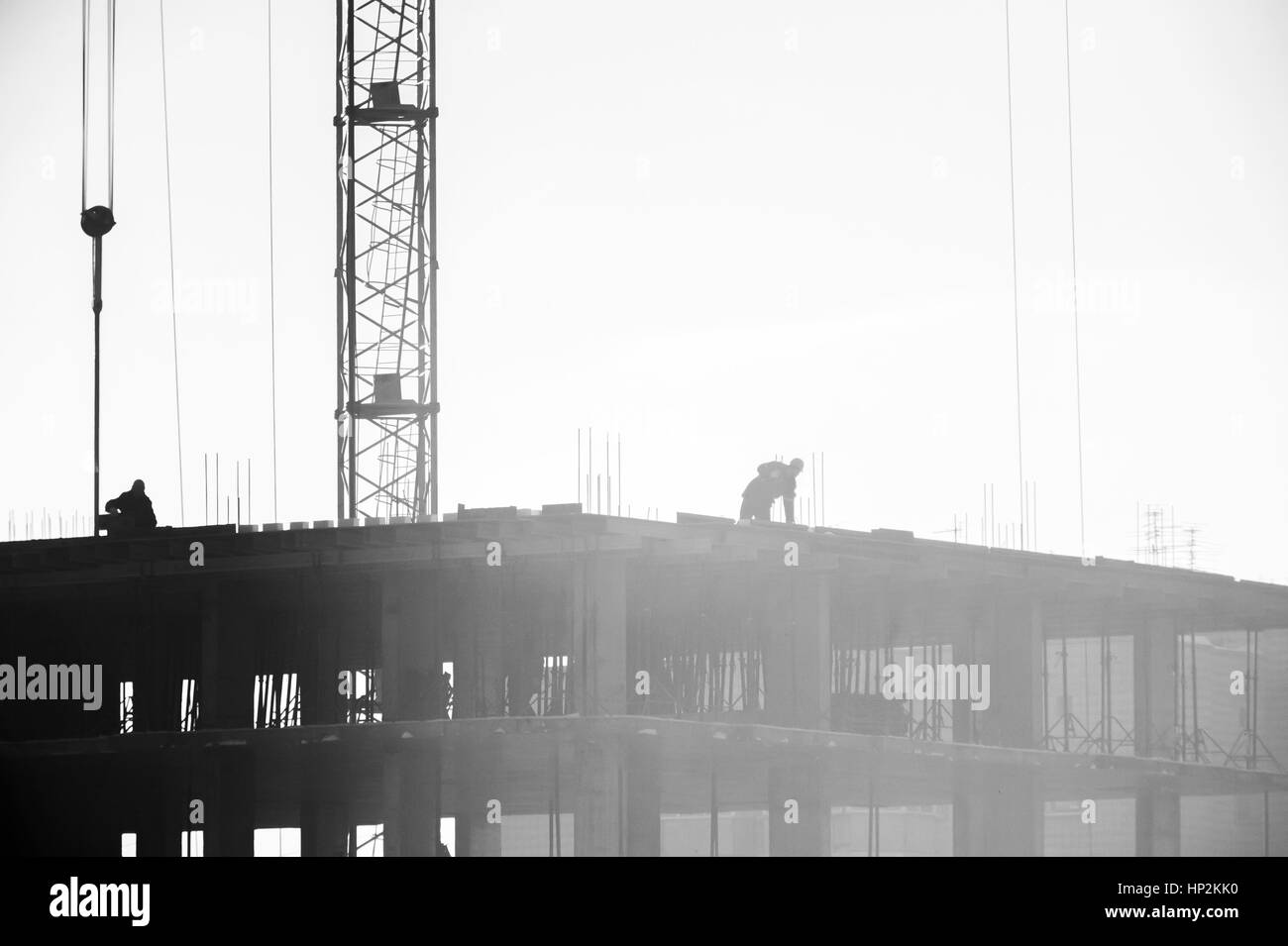 builders working on the construction site, erecting and concrete reinforcement, workflow ...