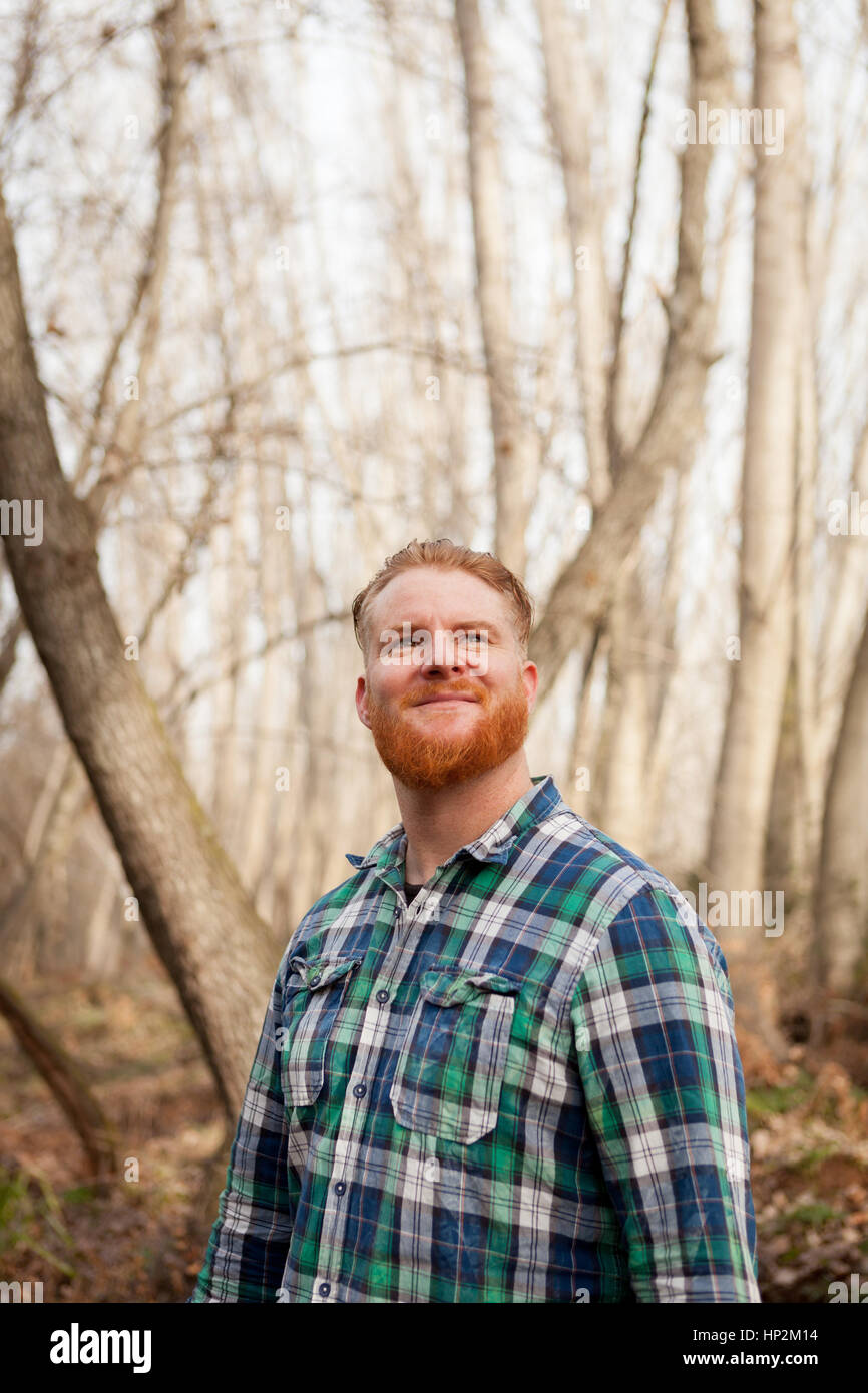Portrait of red haired man with plaid shirt and long beard in the ...