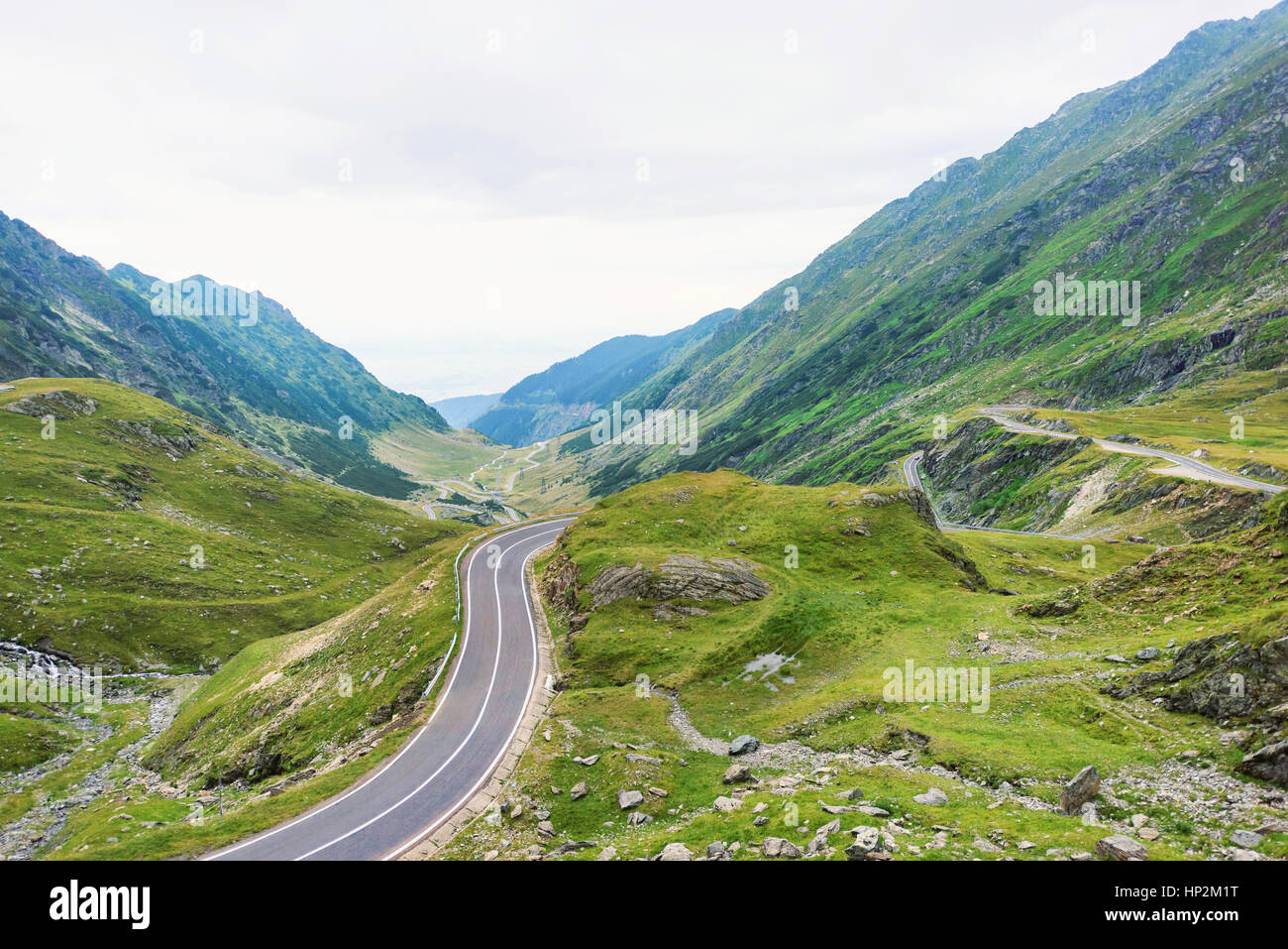 Photo of famous winding road in fagaras at sunset, green mountains ...