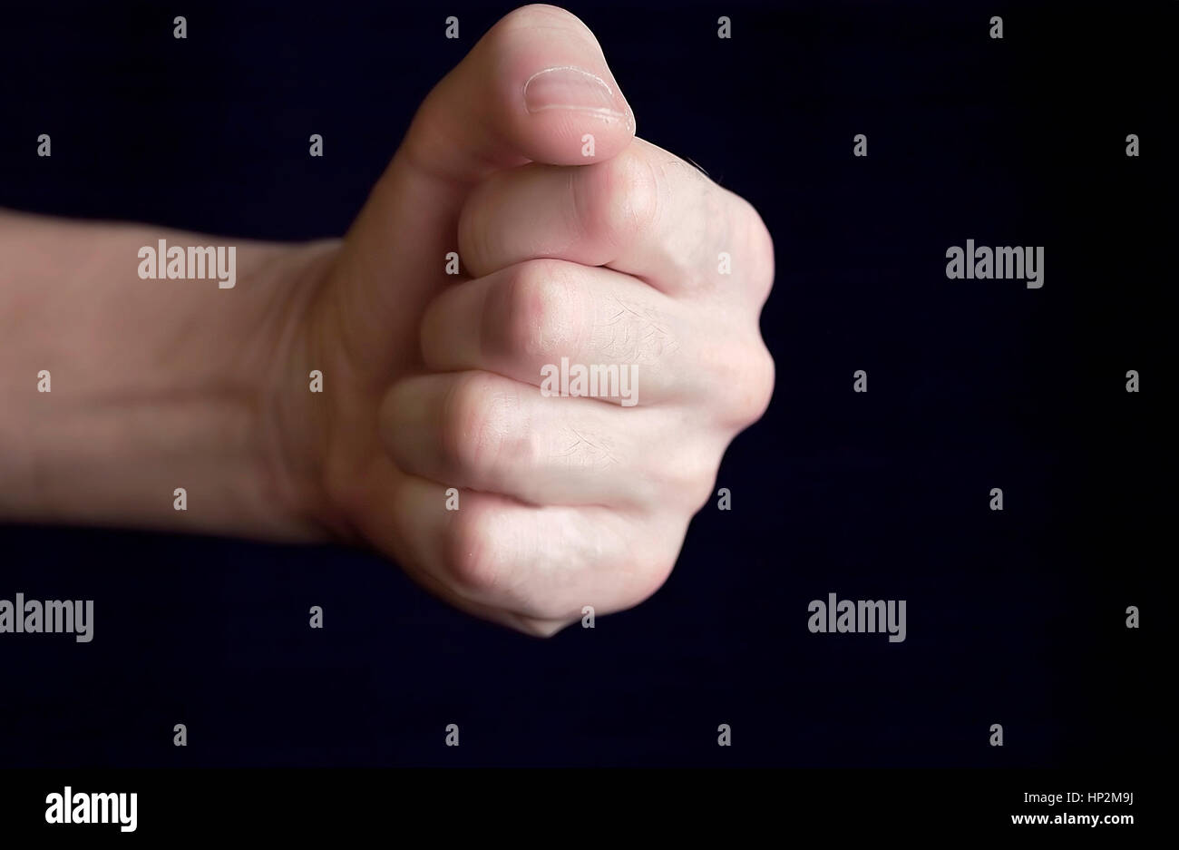 Male fist about to hit, closeup studio shot Stock Photo - Alamy