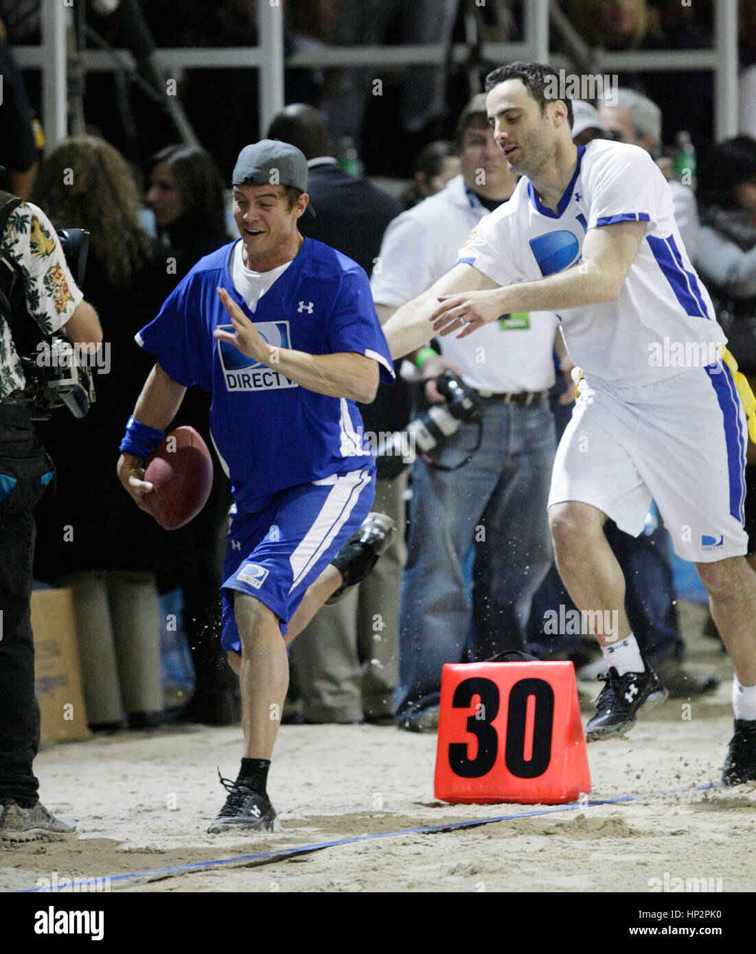 Josh Duhamel, left, runs with the ball while being chased by Dominic ...