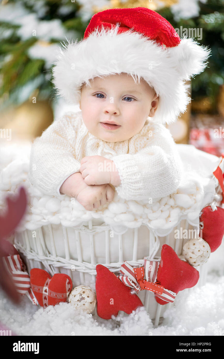 Relaxed little santa boy sitting in the wicker basket Stock Photo - Alamy
