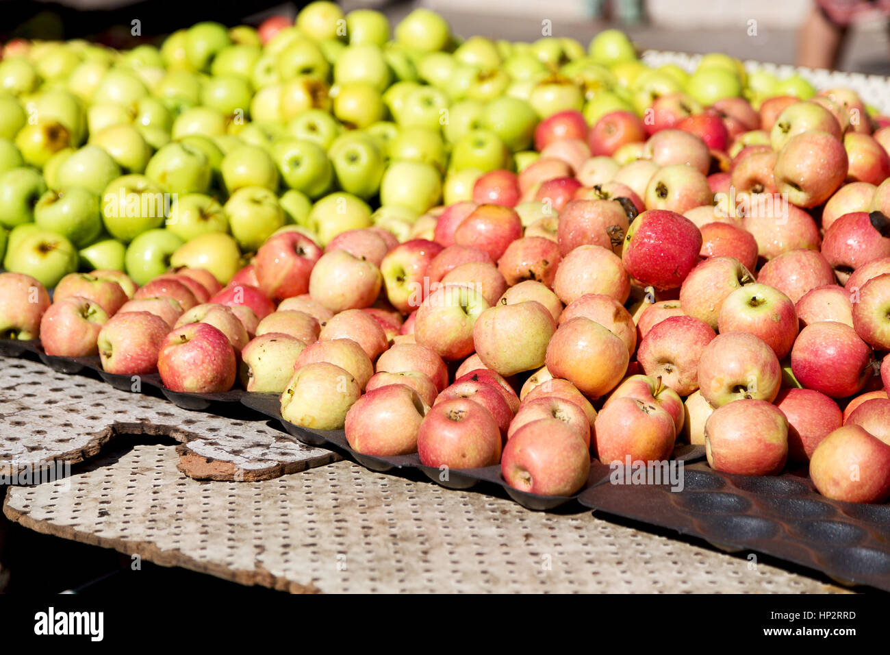 blur in south africa market red and yellow apples in the natural light ...