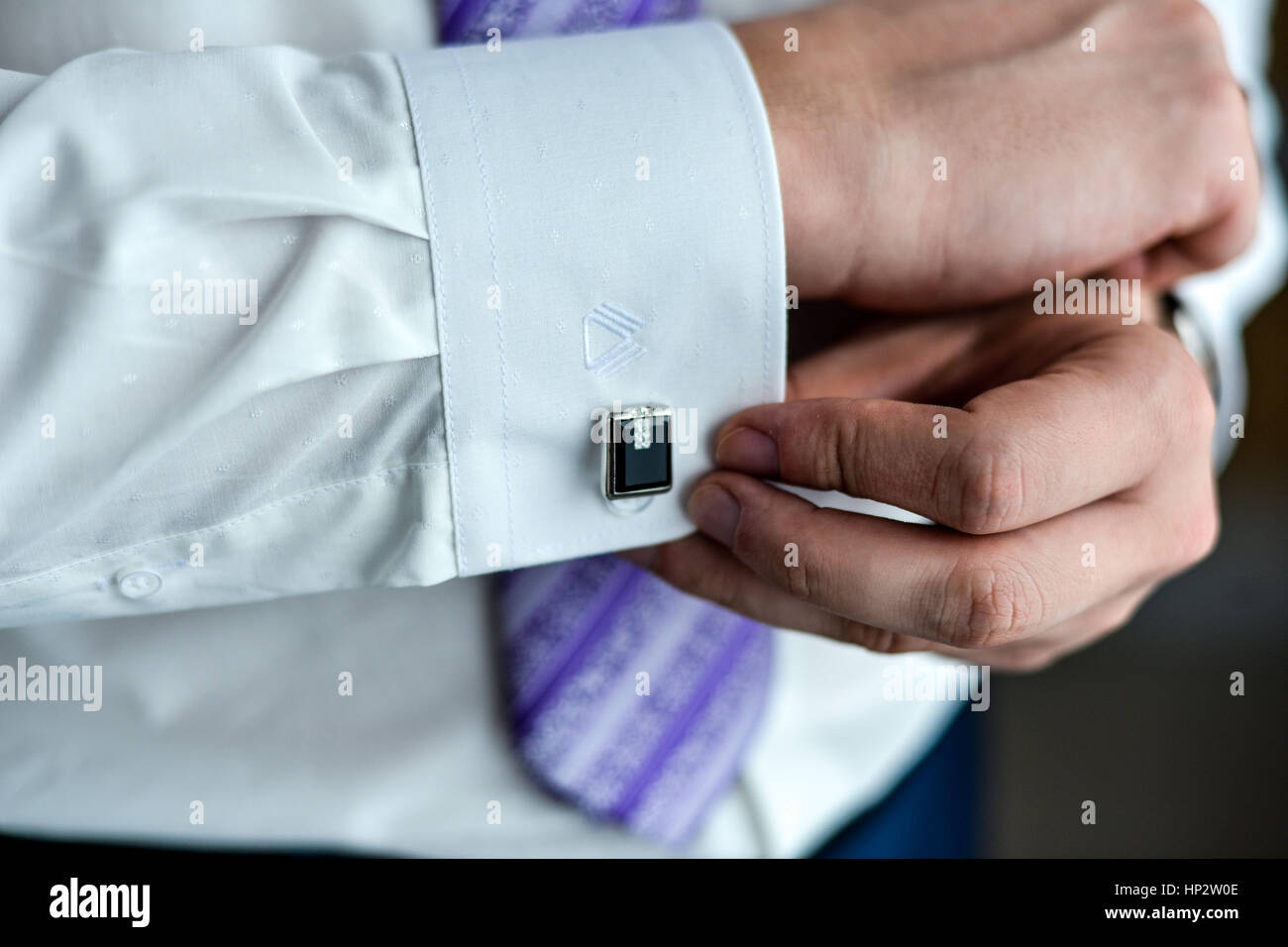 man in a tux fixing his cufflink Stock Photo - Alamy