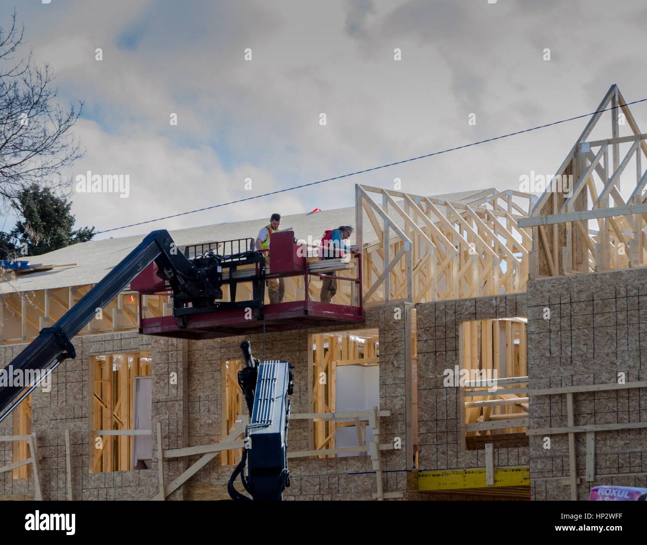 Construction workers load materials at a residential building site in ...