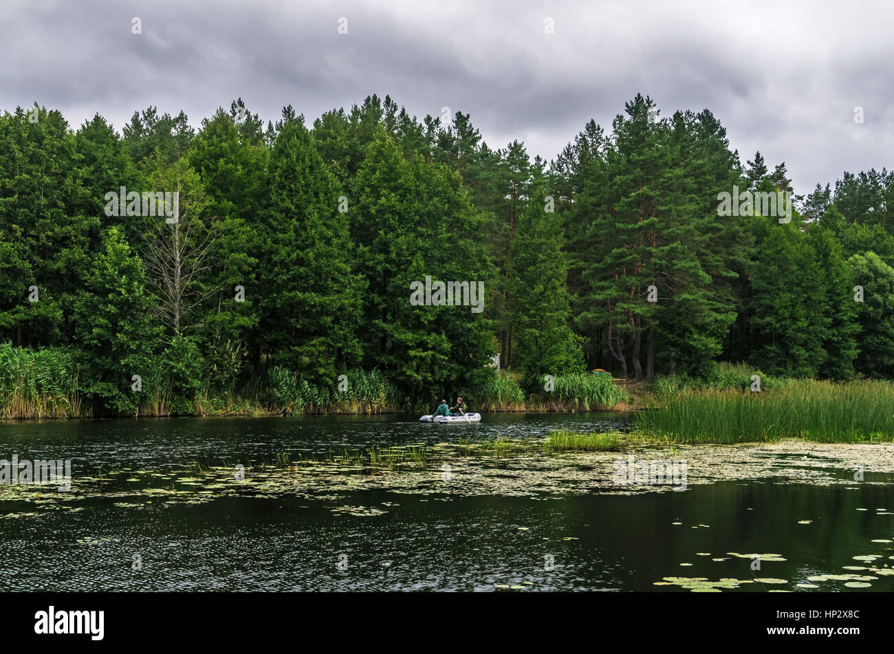 Travel and fishing on forest lake Stock Photo - Alamy