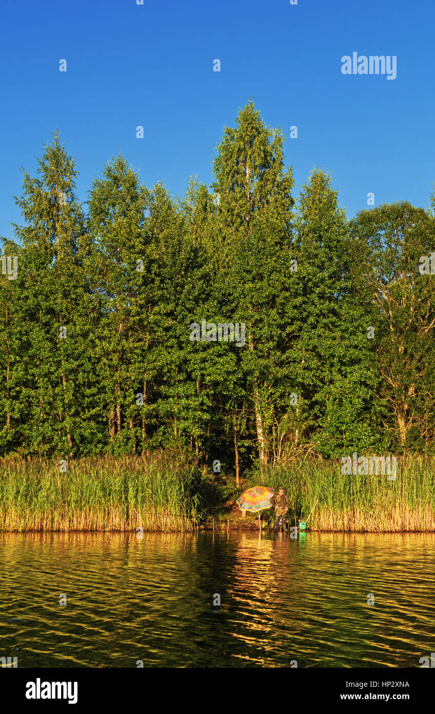 Travel and fishing on forest lake Stock Photo - Alamy