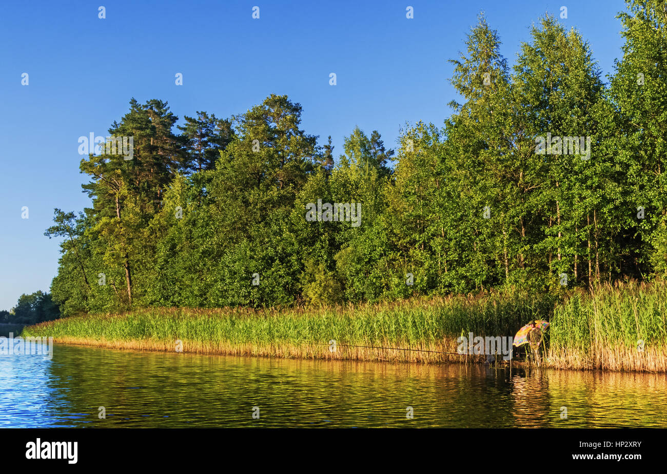 Travel and fishing on forest lake Stock Photo - Alamy