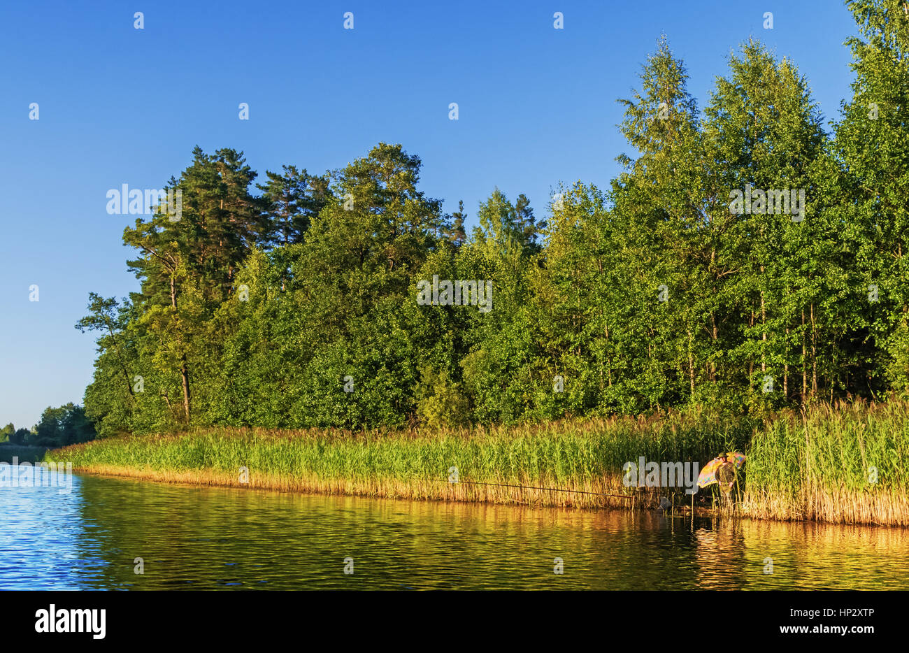 Travel and fishing on forest lake Stock Photo - Alamy