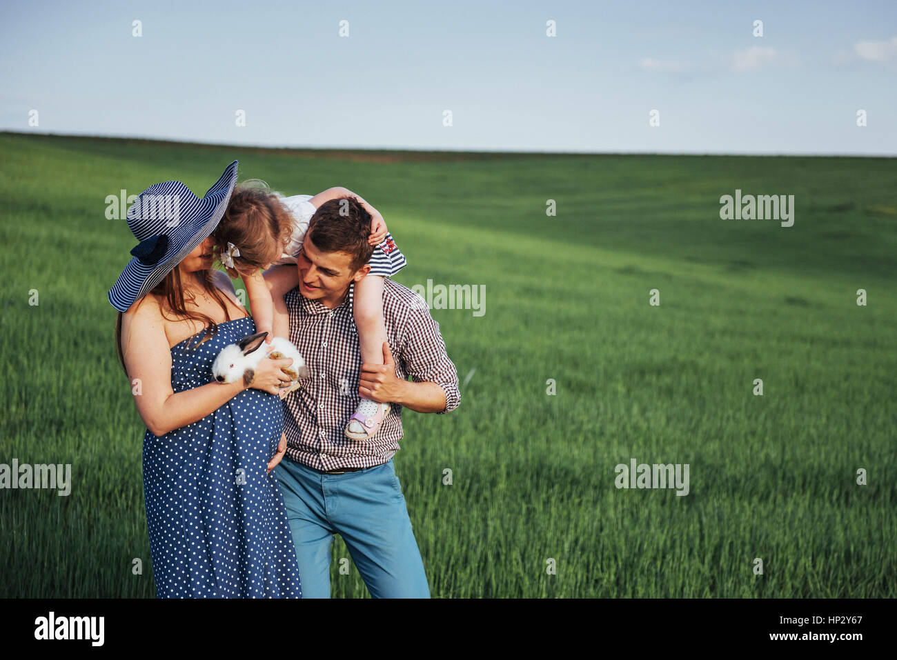 Happy family of three people hugging in the streets Stock Photo - Alamy