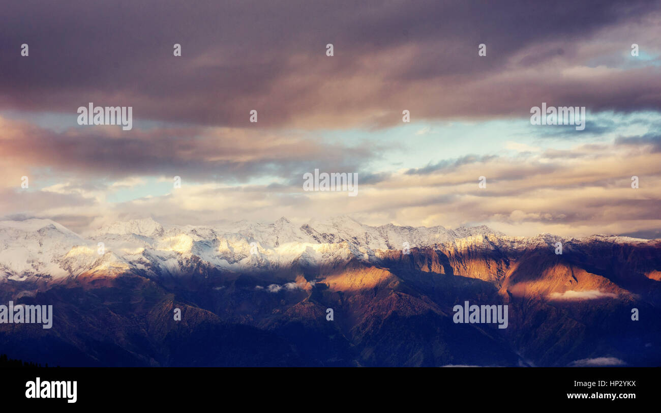 Fantastic snow-capped mountains in the beautiful cumulus clouds Stock ...