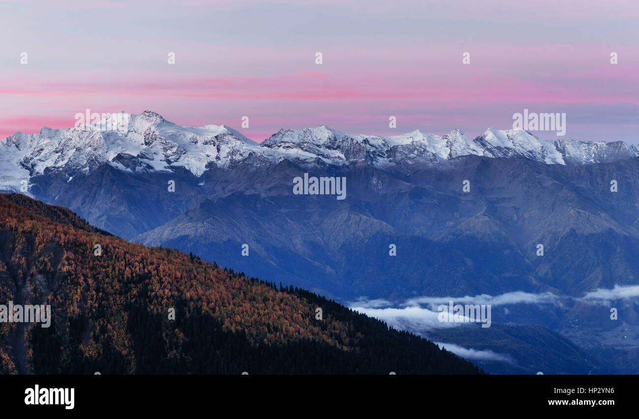 Fantastic snow-capped mountains in the beautiful cumulus clouds Stock ...
