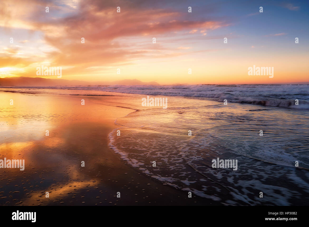 sunset on beach shore Stock Photo - Alamy