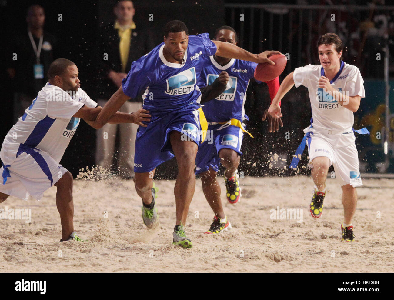 Michael Strahan, center, is chased by Josh Hutcherson, right, and ...