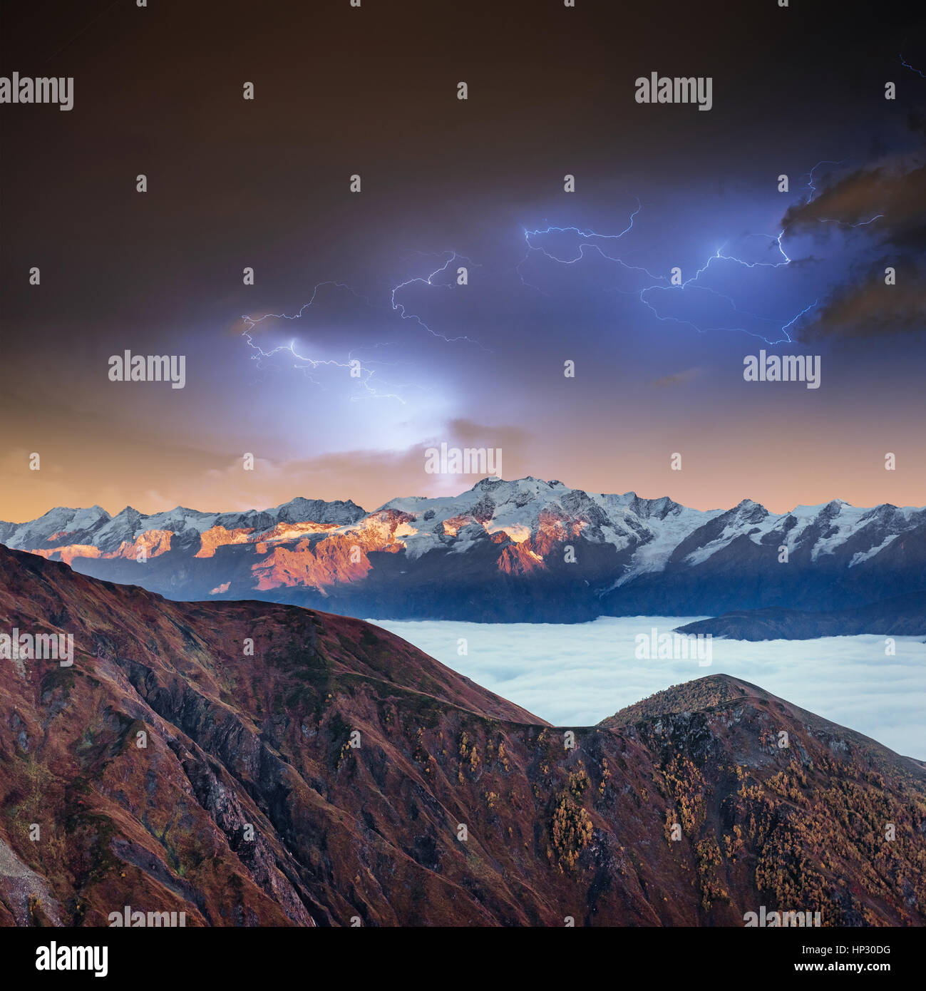 Fantastic collage. Beautiful lightning over the snow-capped Stock Photo ...