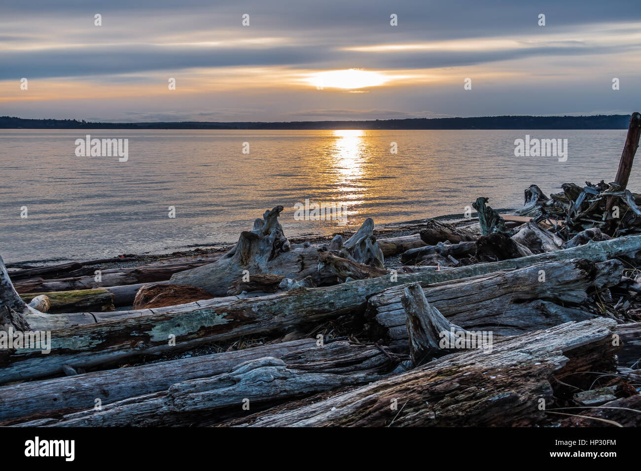 The sun sets behind overcast skies in Normandy Park, Washington Stock ...