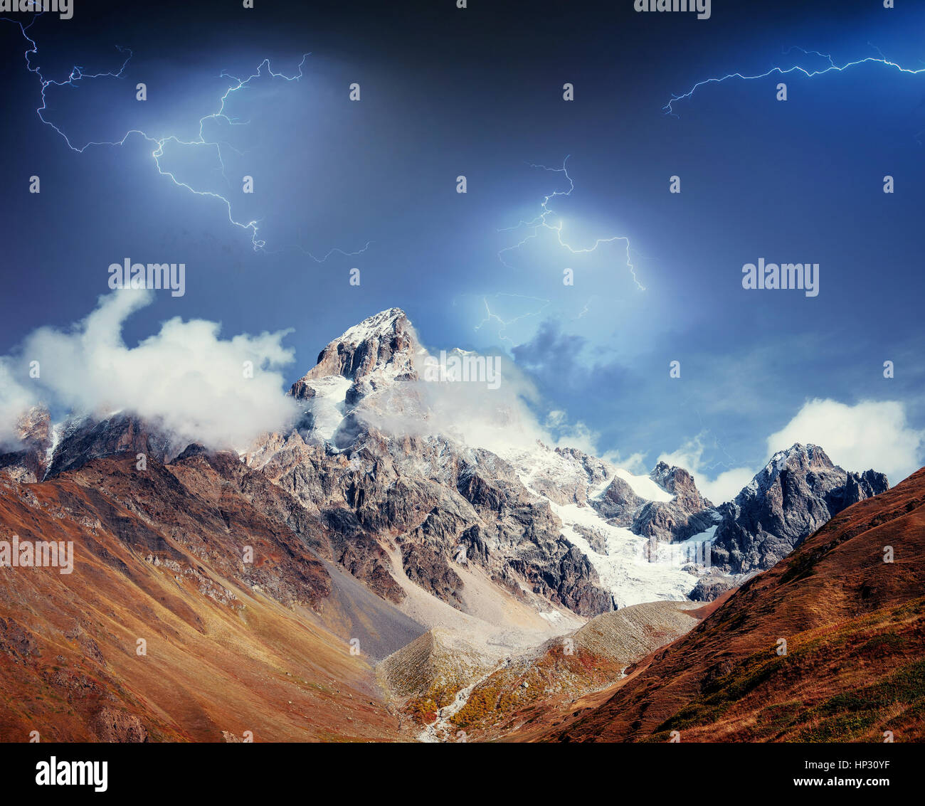 Fantastic collage. Beautiful lightning over the snow-capped moun Stock ...