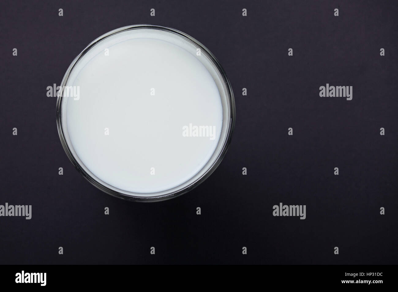 Transparent glass of milk on a black background Stock Photo - Alamy