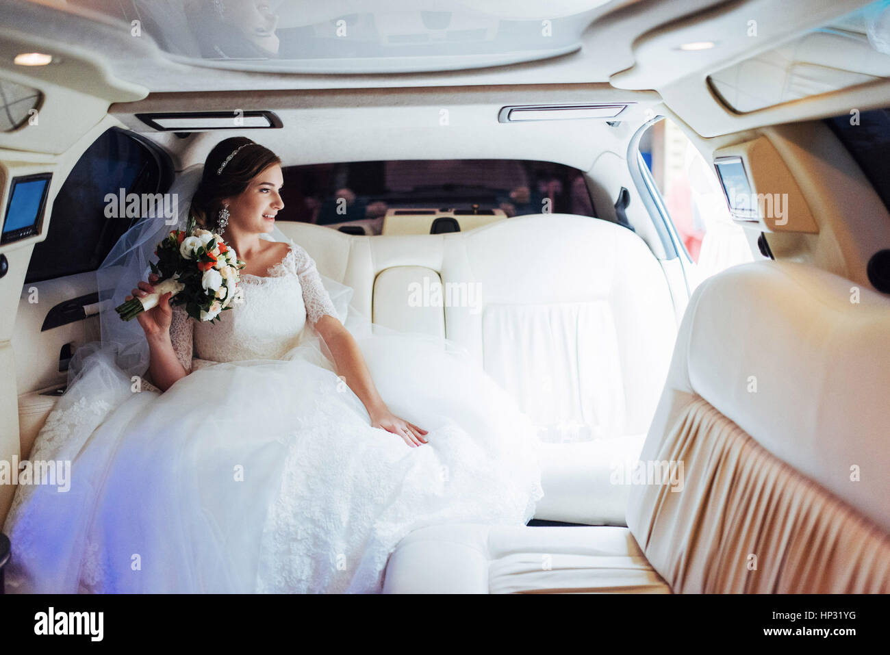 Portrait of a beautiful young bride in the car Stock Photo - Alamy